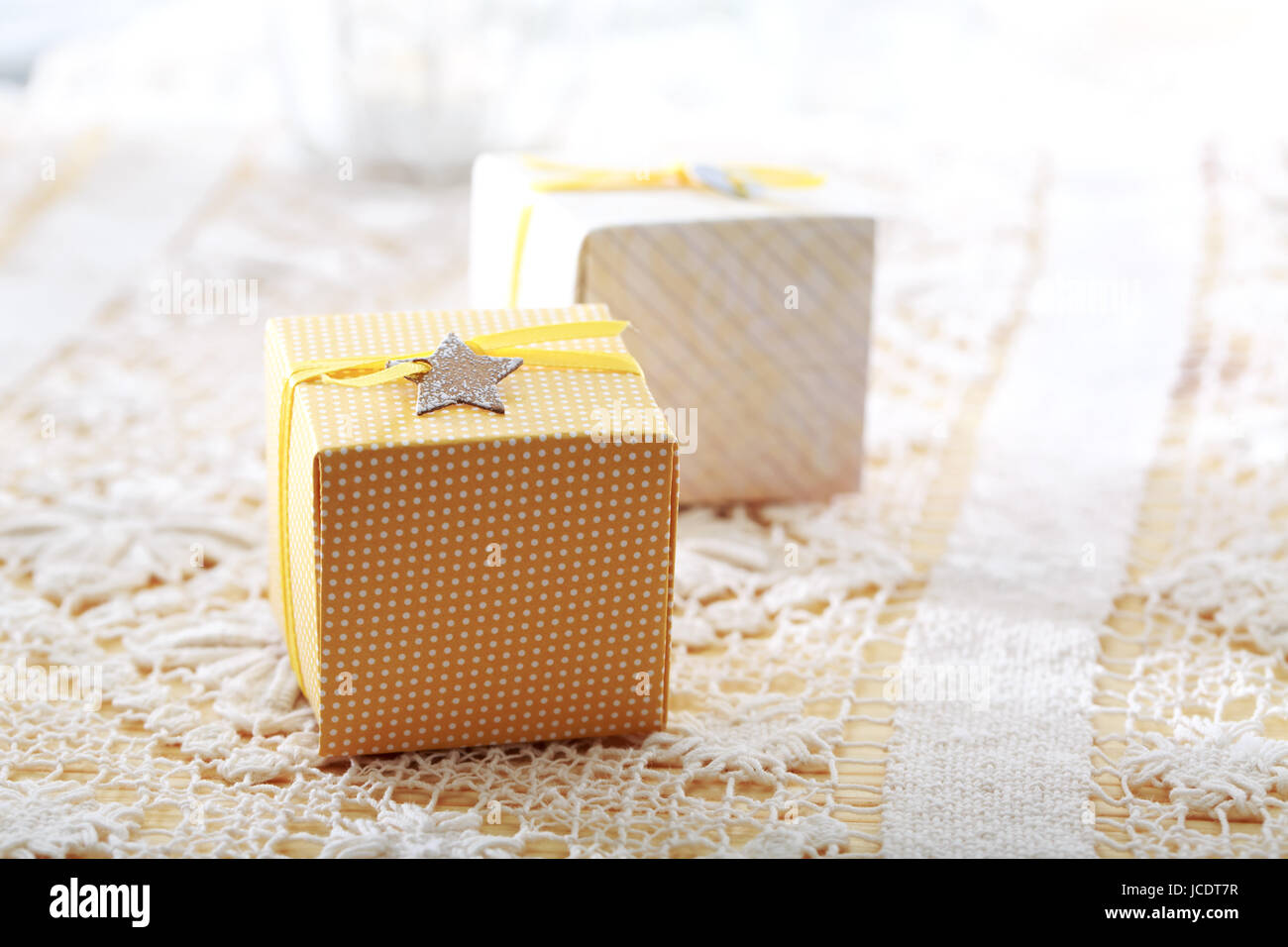 Hand made present boxes with yellow ribbons and star shaped tags Stock ...