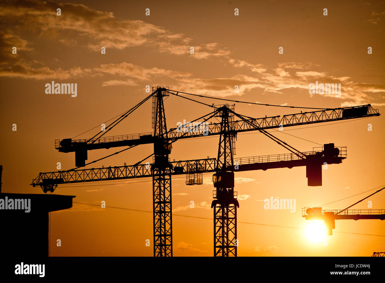 Color picture of some cranes on a construction site, as dusk Stock ...