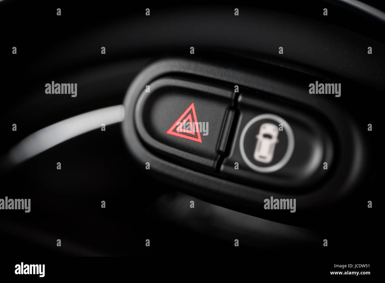 Detail of a warning button in a car Stock Photo - Alamy