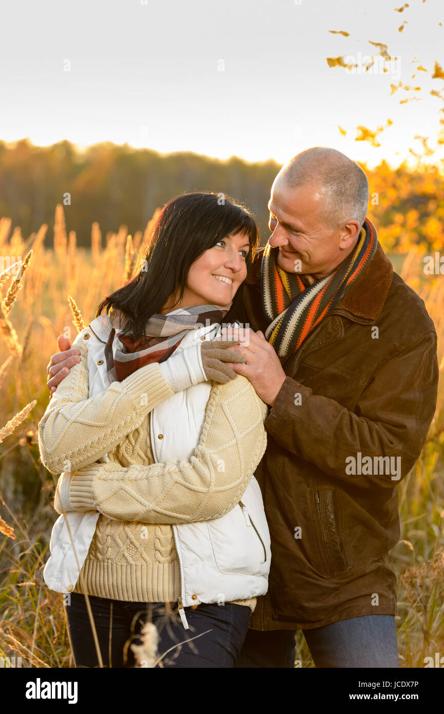 Couple in love hugging sunset autumn countryside looking each other ...