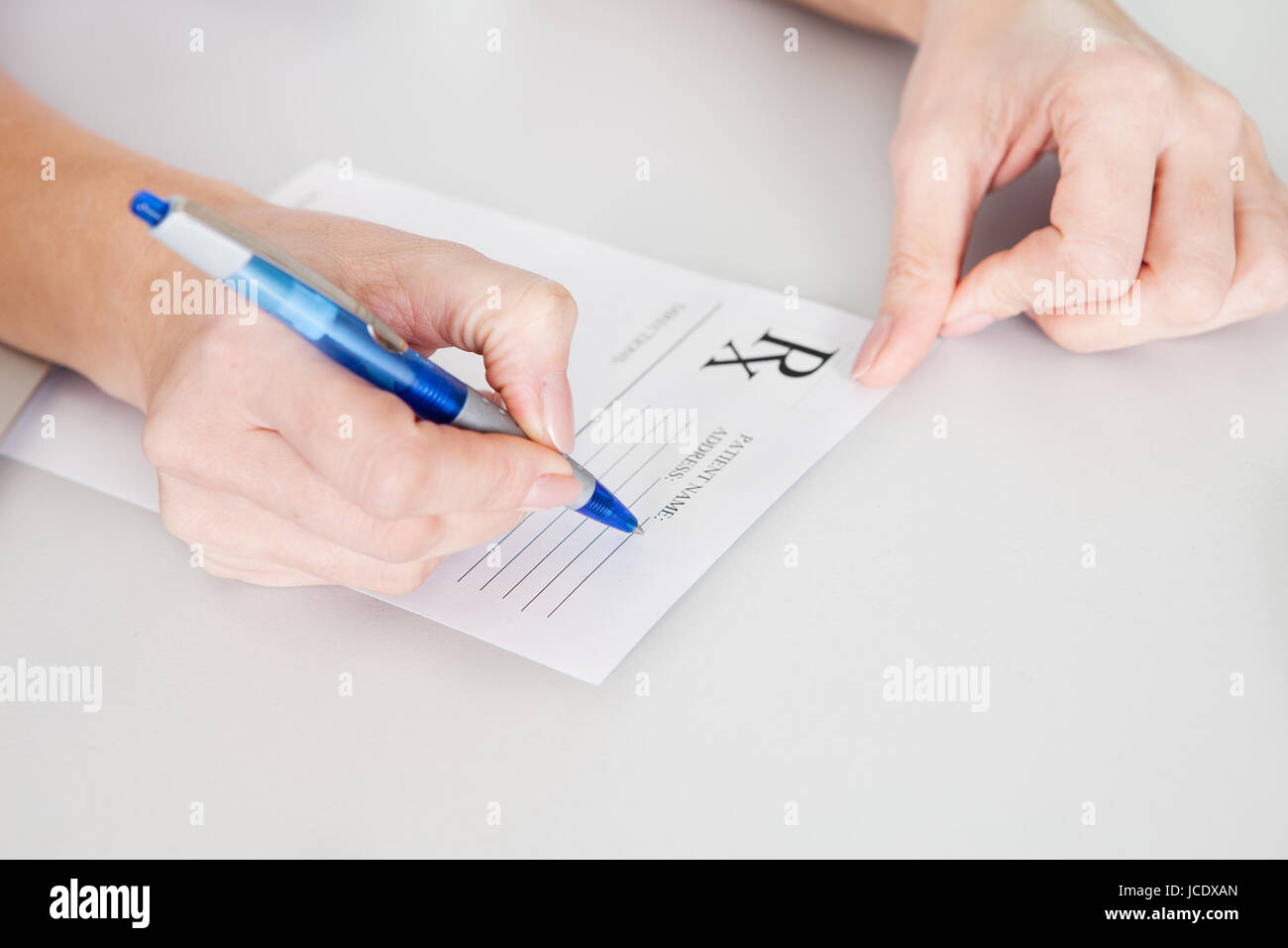 Cheerful medical doctor woman filling out prescription. Isolated on ...