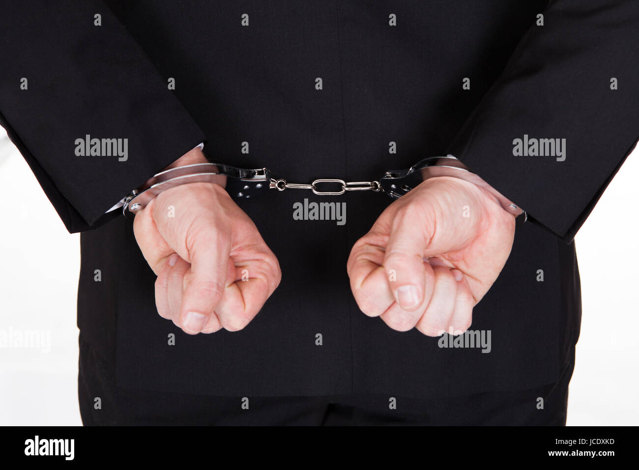 Rear view of arrested businessman with handcuffs Stock Photo - Alamy