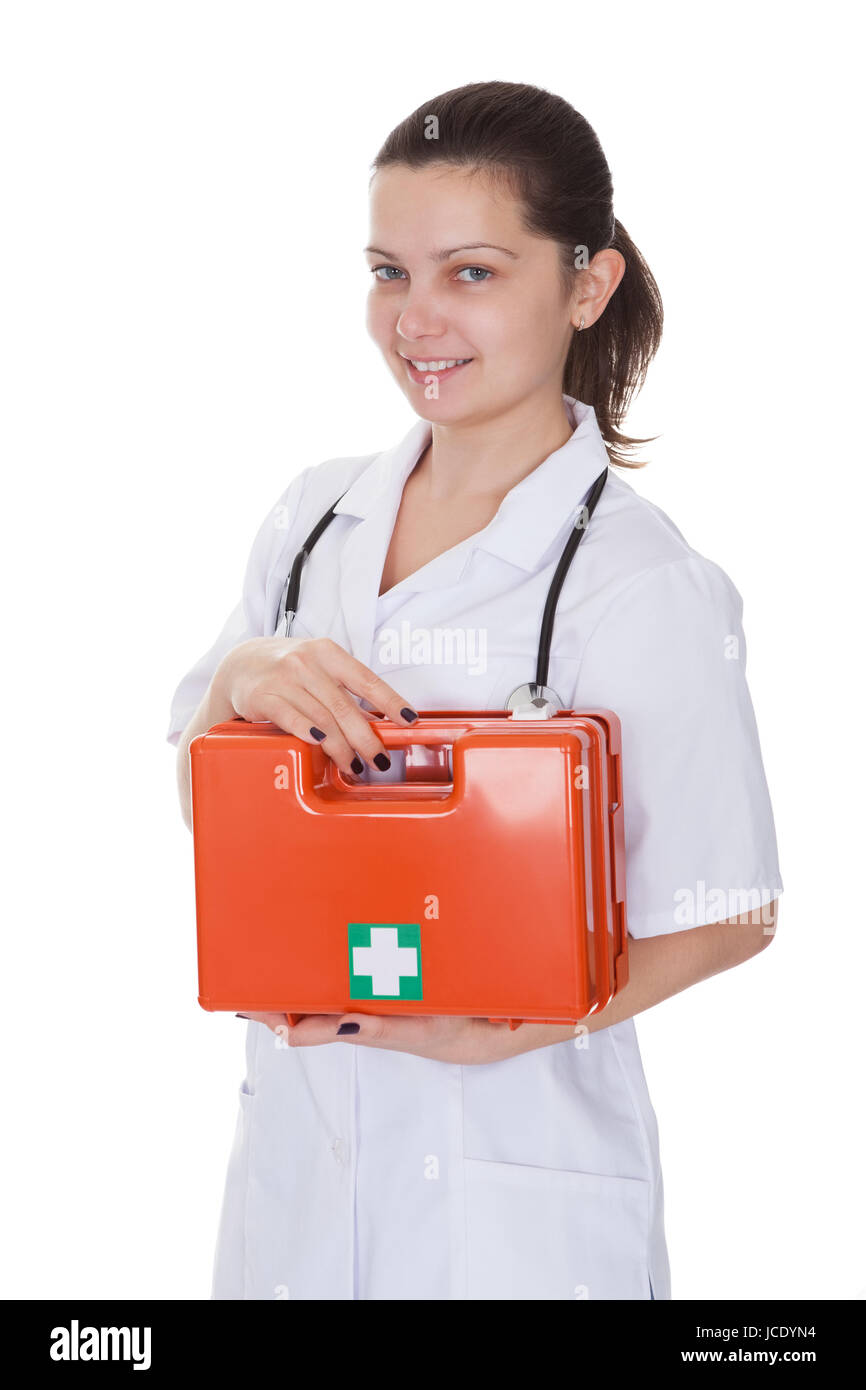 Attractive young smiling female nurse or doctor carrying a portable ...