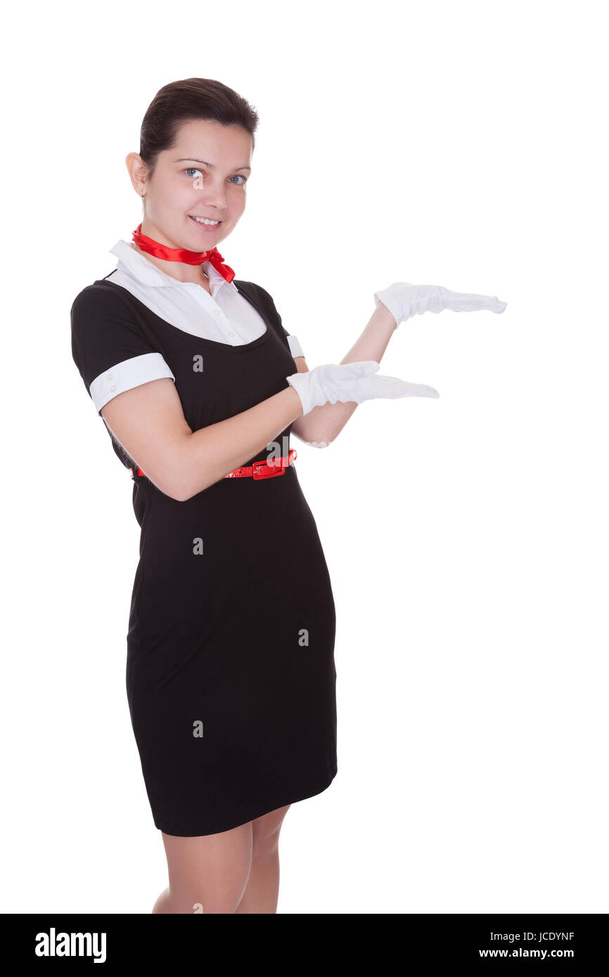 Pretty young flight attendant or hostess in a smart uniform isolated on ...