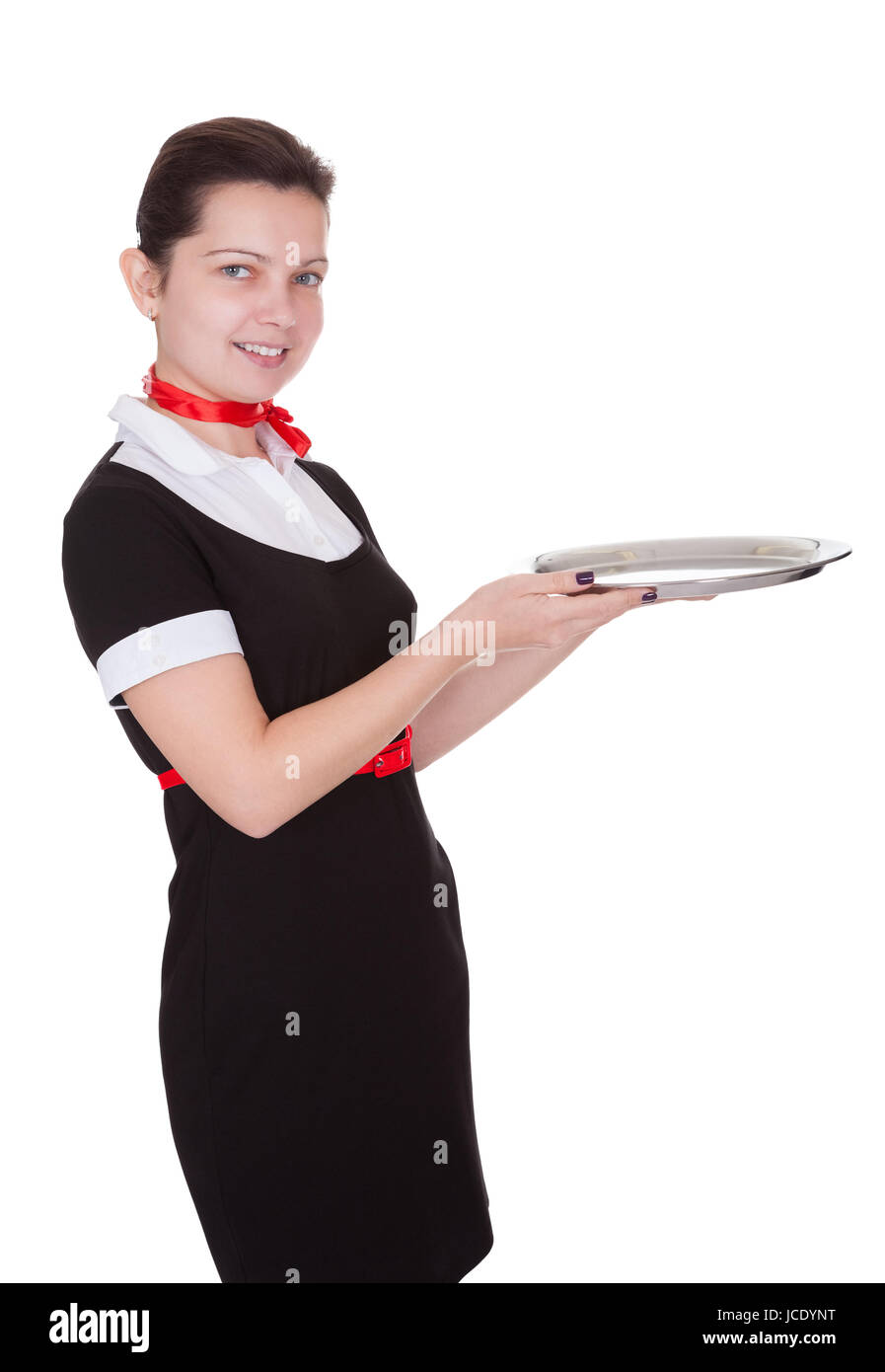 Attractive young waitress in a smart uniform holding an empty service ...