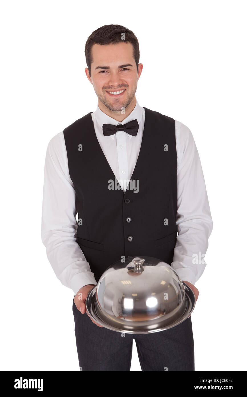 Portrait of a cheerful young butler. Isolated on white Stock Photo - Alamy
