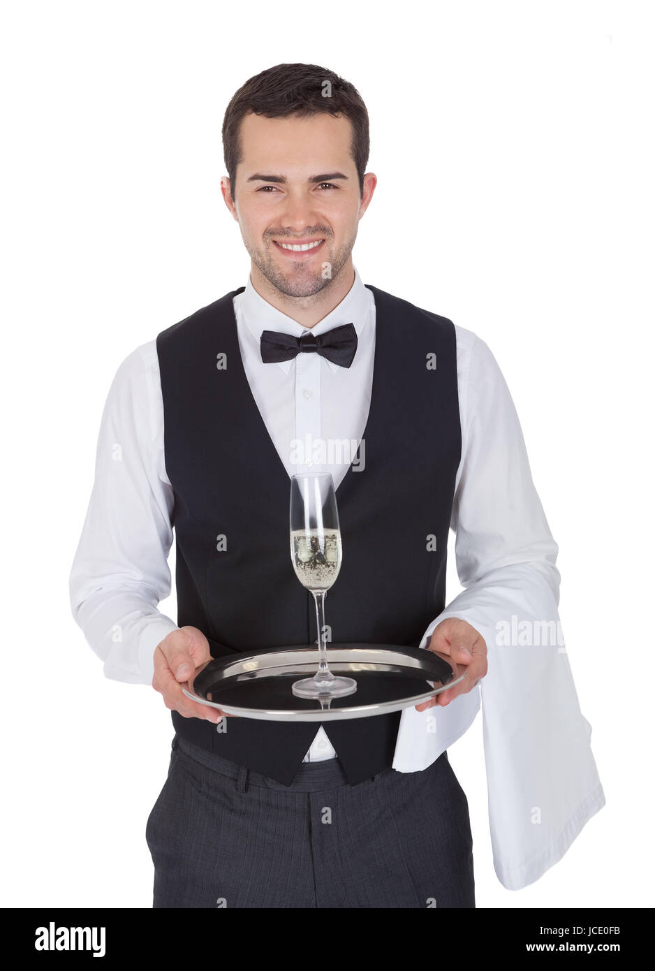 Portrait of a young butler with champagne glass. Isolated on white ...