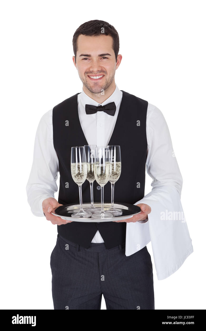 Portrait of a young butler with champagne glass. Isolated on white ...