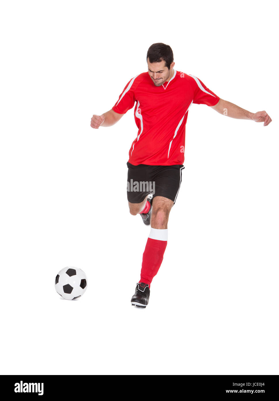 Professional soccer player kicking ball. Isolated on white Stock Photo ...