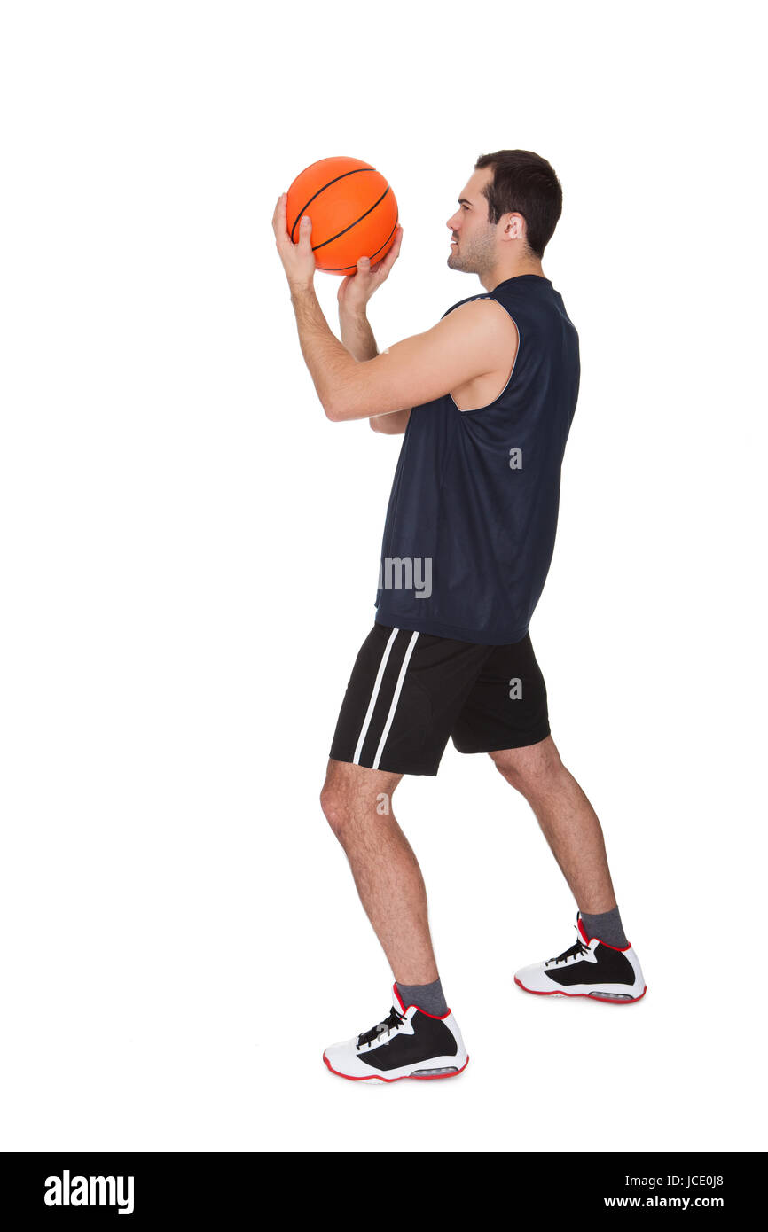 Professional basketball player throwing the ball. Isolated on white ...