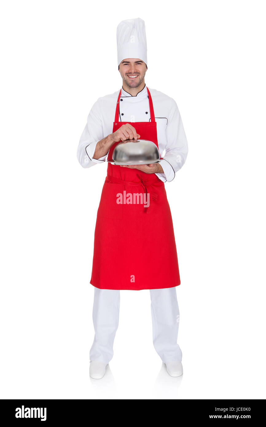 Portrait of cheerful chef with silver tray. Isolated on white Stock ...