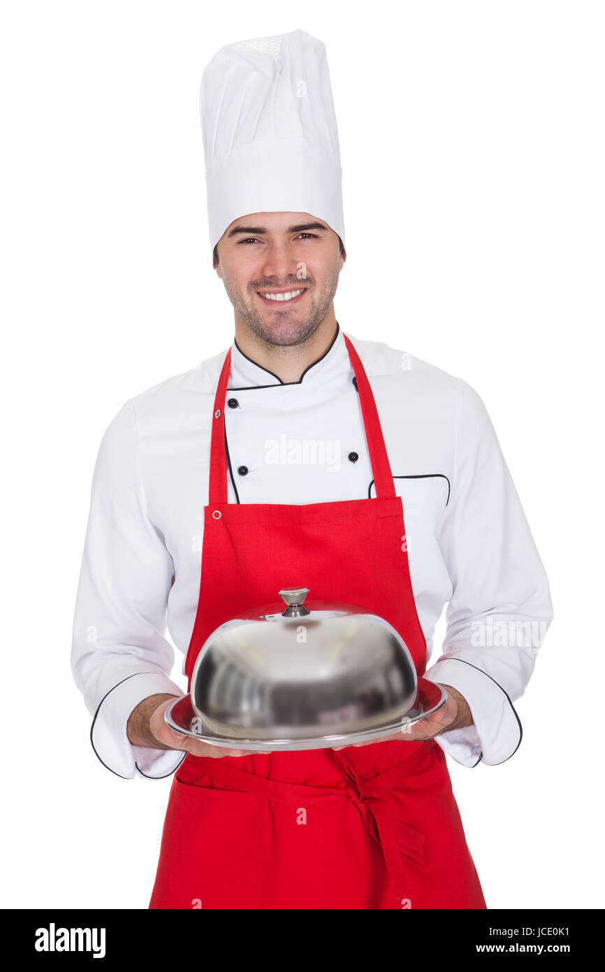 Portrait of cheerful chef with silver tray. Isolated on white Stock ...