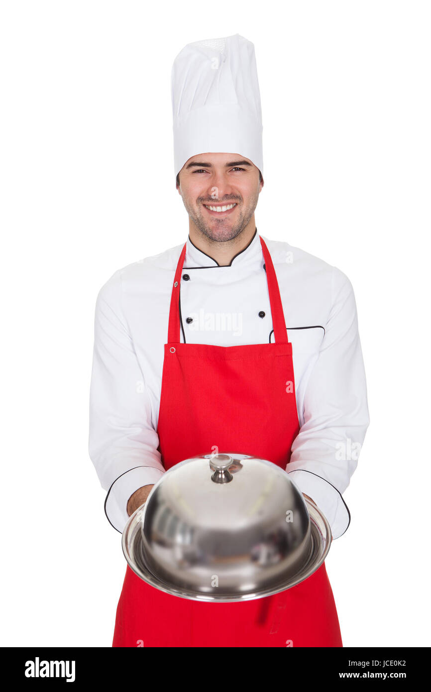 Portrait of cheerful chef with silver tray. Isolated on white Stock ...