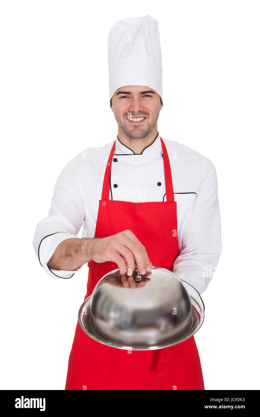 Portrait of cheerful chef with silver tray. Isolated on white Stock ...