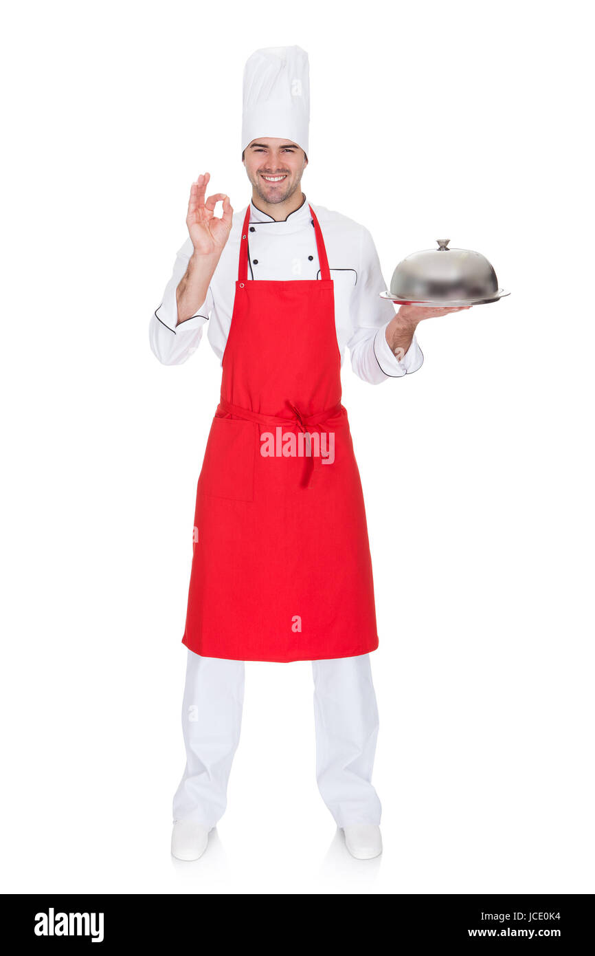 Portrait of cheerful chef with silver tray. Isolated on white Stock ...