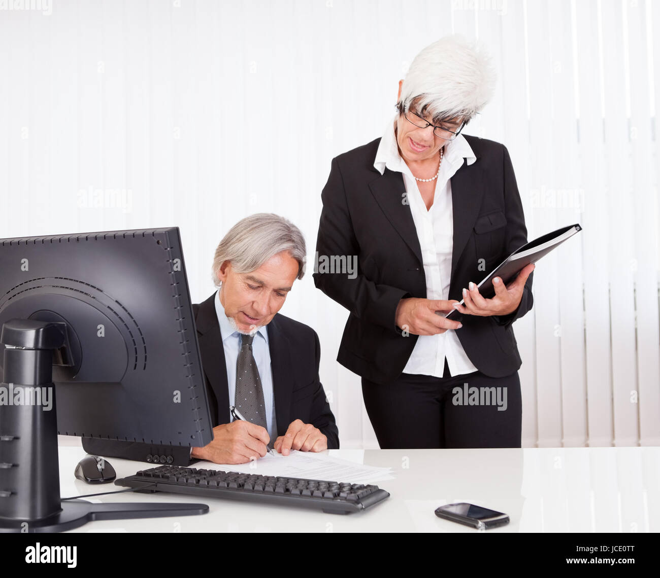 Man seated secretary desk hi-res stock photography and images - Alamy