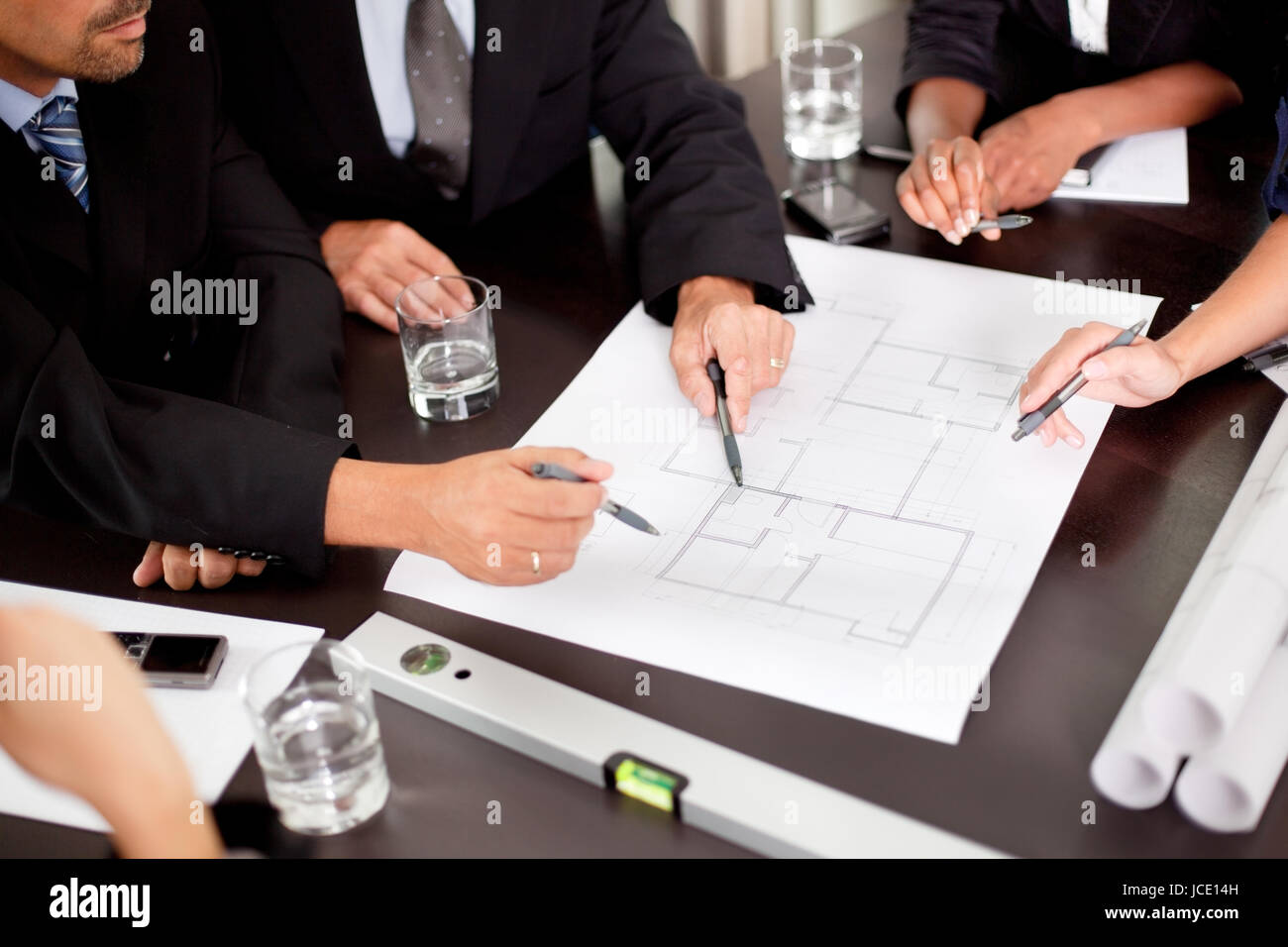 Architects discussing at the table with blueprint - Closeup on hands ...