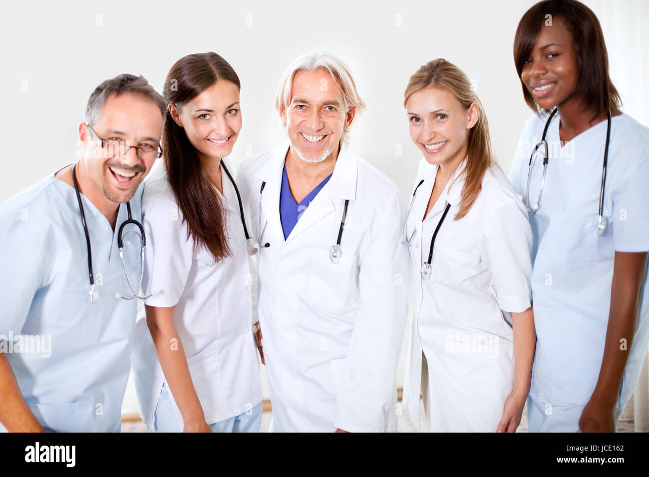 Portrait smiling doctors and colleagues standing together - Smiling at ...