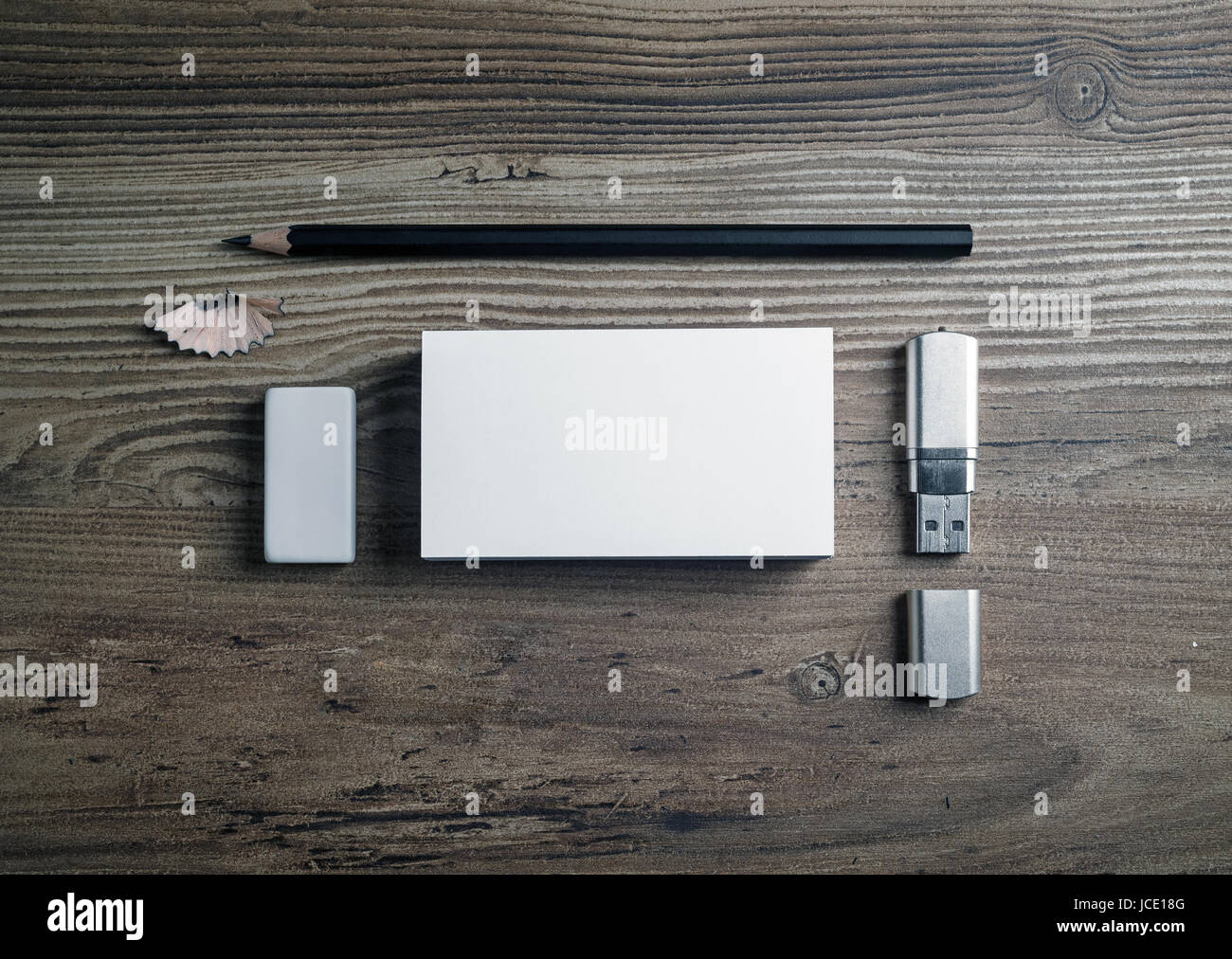 Business cards, pencil, eraser, flash drive and sharpener on wood table ...