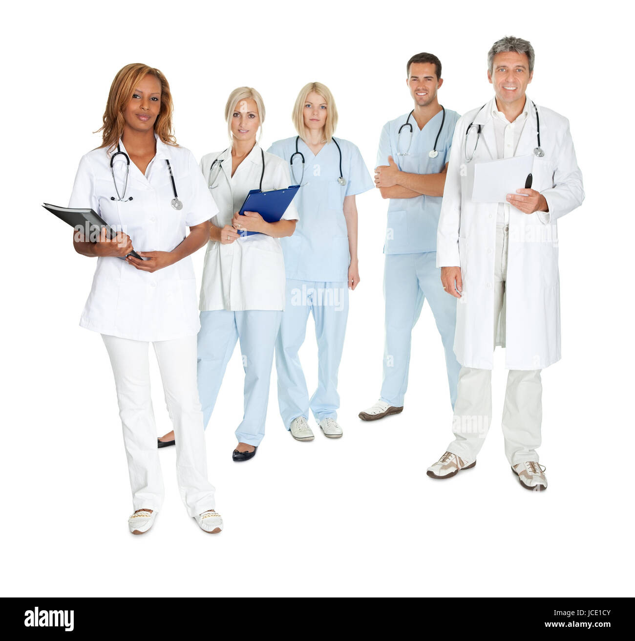 Happy team of doctors and surgeons standing isolated on white ...