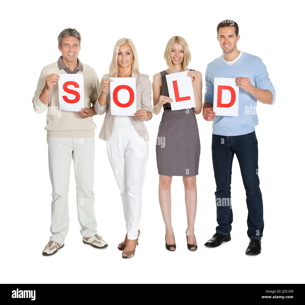 Happy group of people holding sold sign isolated on white background ...