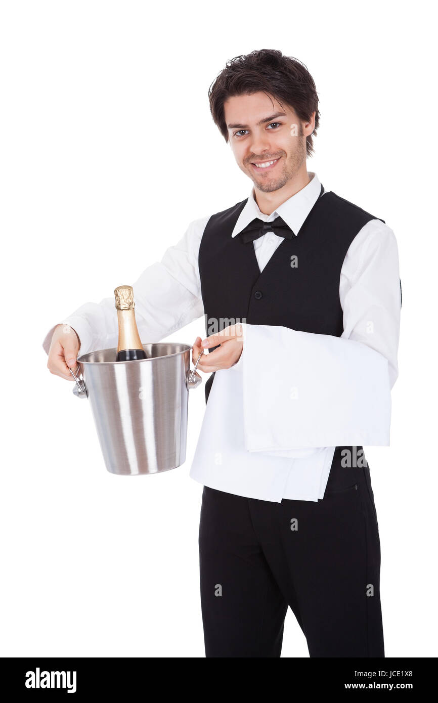 Portrait of a butler with bottle of champagne in a bucket. Isolated on ...