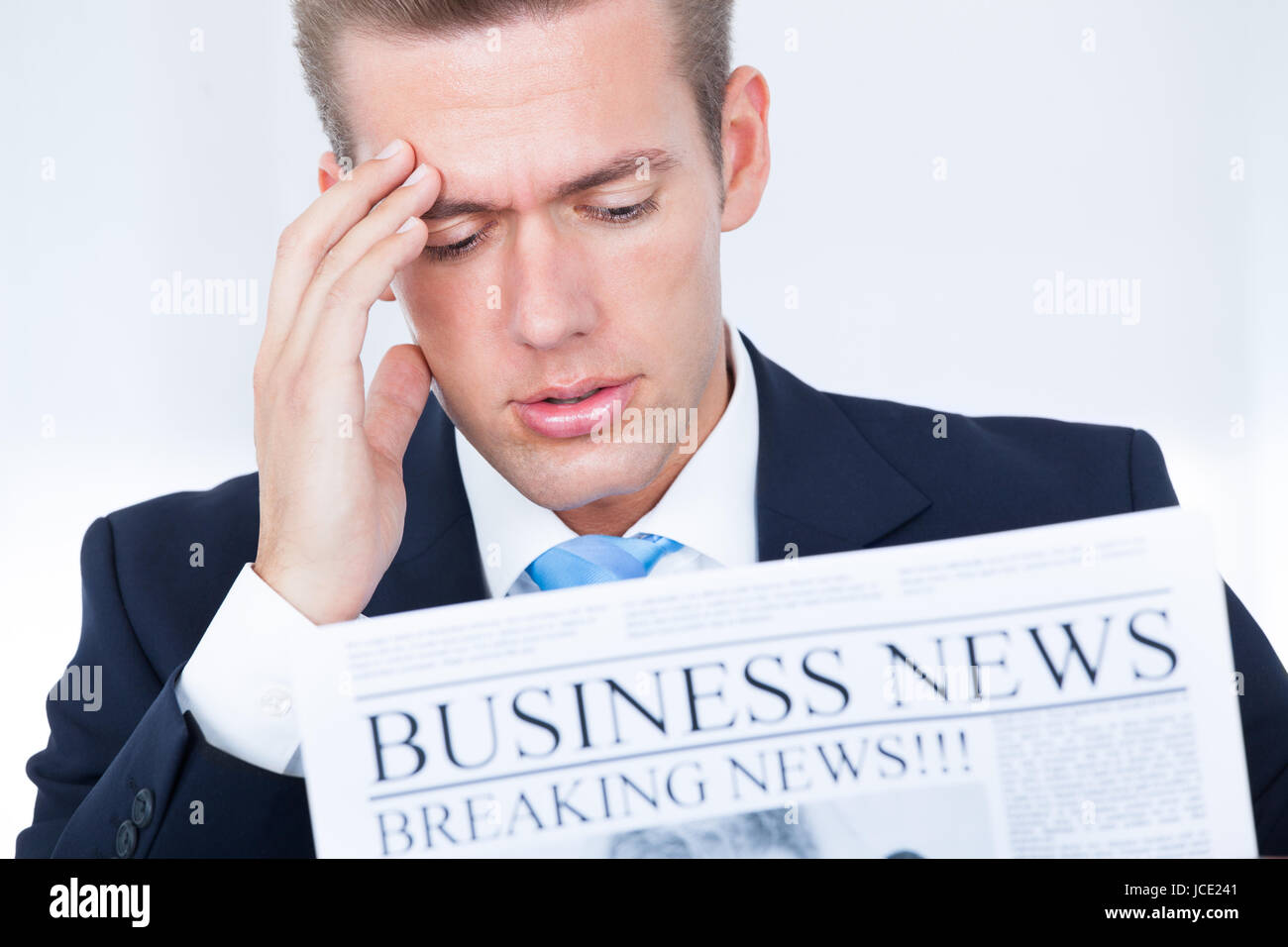 Young Businessman Reading Breaking News On Newspaper Stock Photo - Alamy