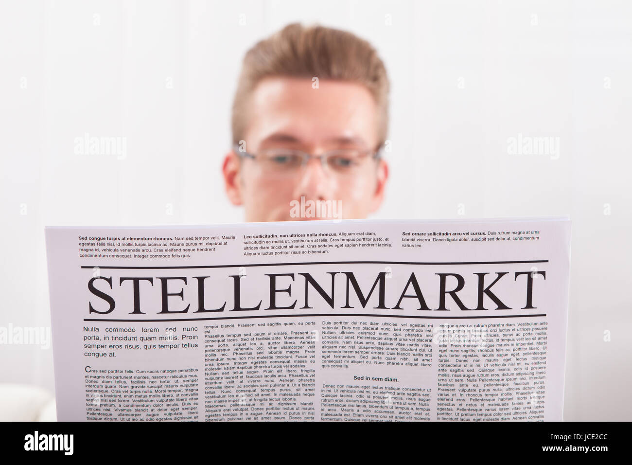 Man Reading Newspaper With The Headline Job Market Stock Photo - Alamy