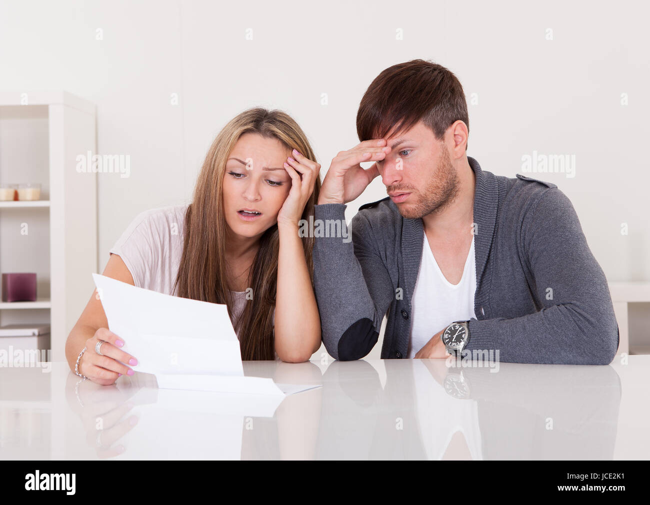Shock portrayed on man's face after reading letter Stock Photo - Alamy