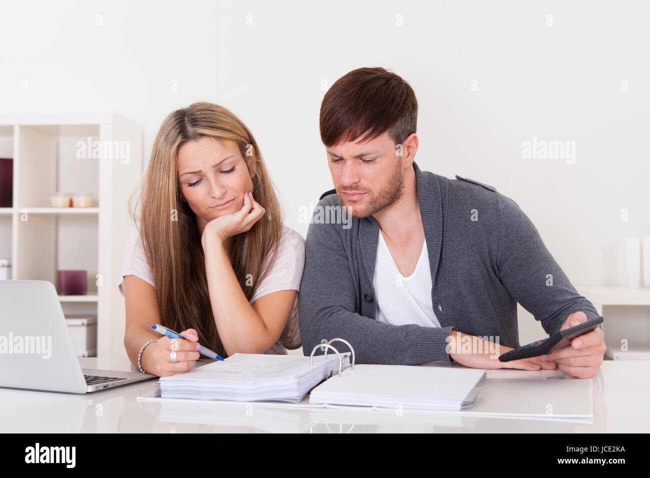 Unhappy young couple in financial trouble at home Stock Photo - Alamy