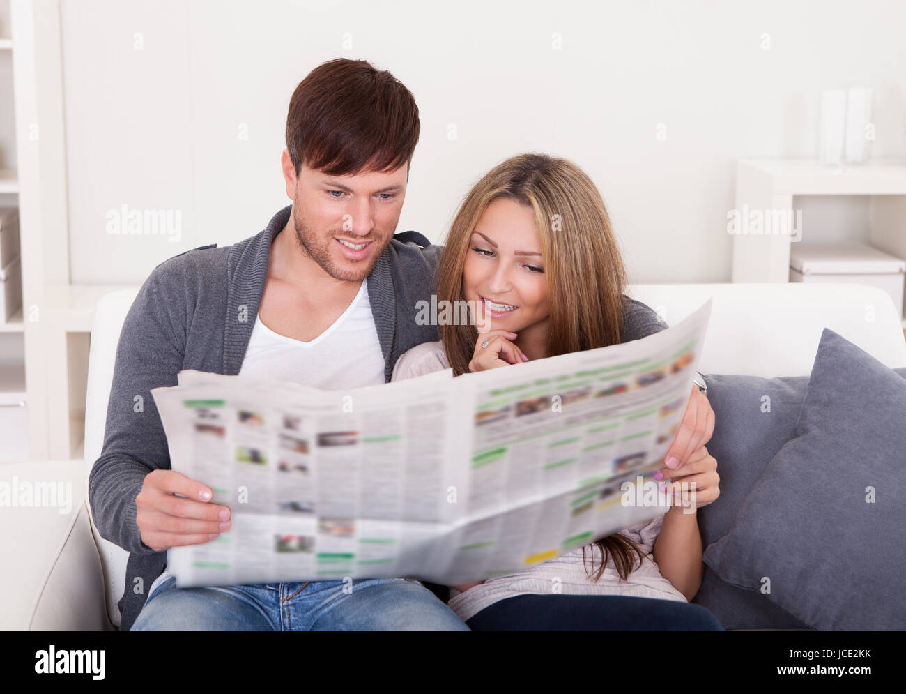 Both read recent article dealing relationships from newspaper Stock ...