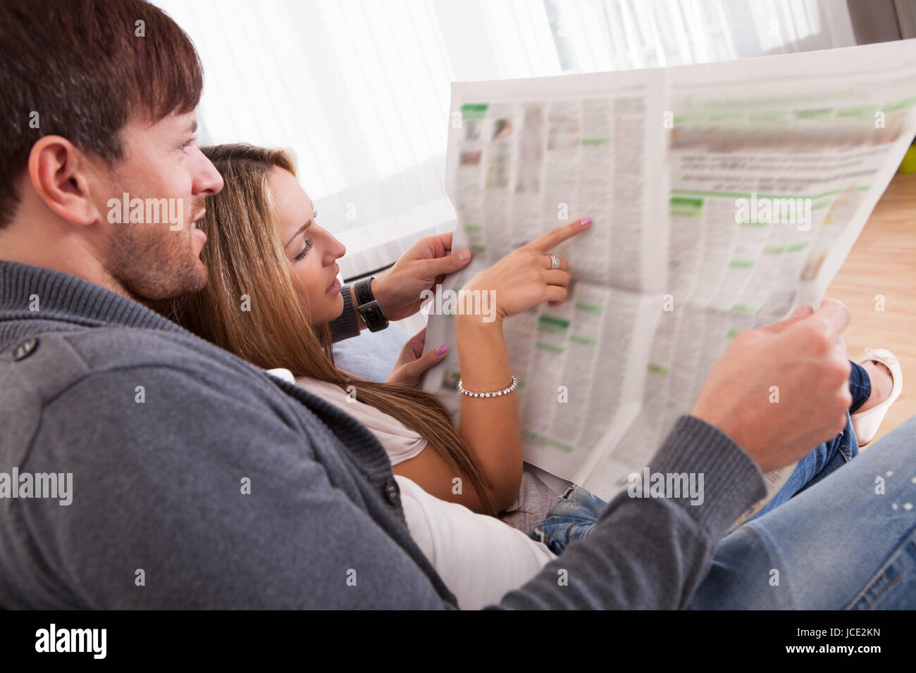 Both read recent article dealing relationships from newspaper Stock ...