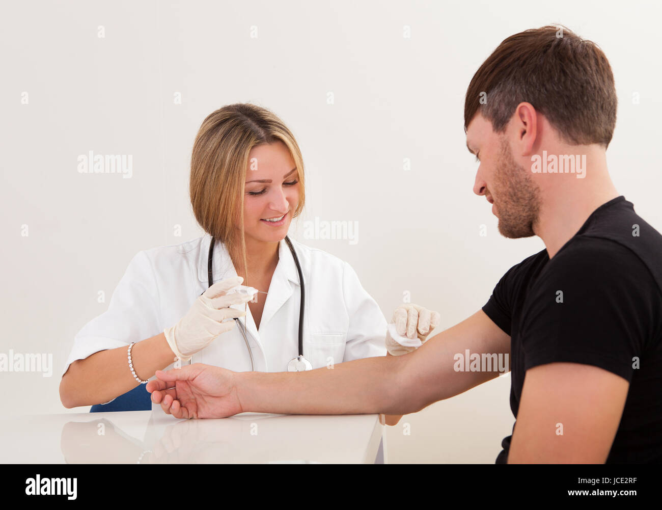 Nurse making injection to patient in clinic Stock Photo - Alamy