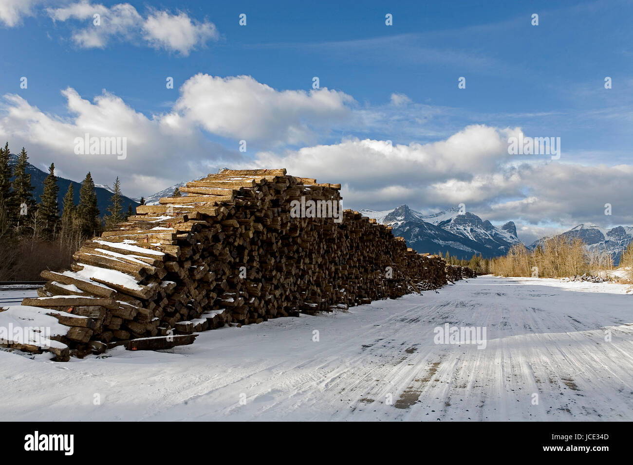 a big pile of wood outdoors with mountain scenery Stock Photo - Alamy