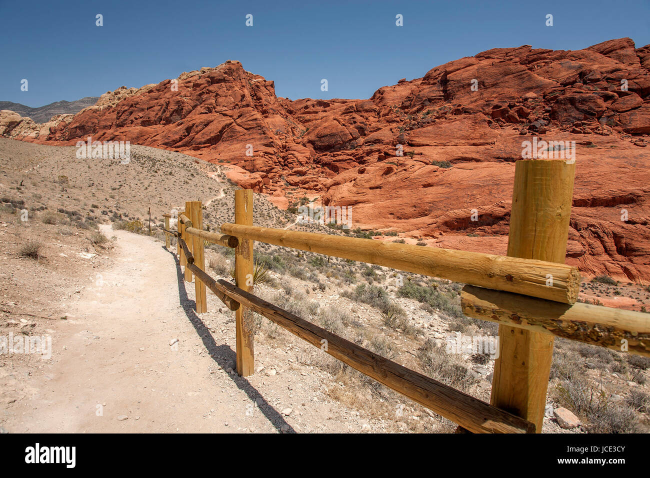 mountain pathway wooden railing with red cliffs in background Stock ...