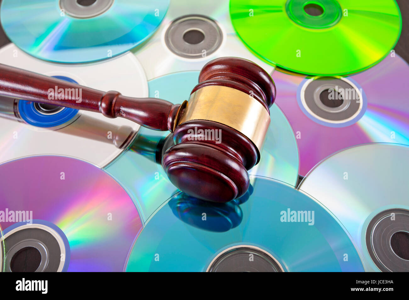 bulk writable compact disc background with gavel on top Stock Photo - Alamy