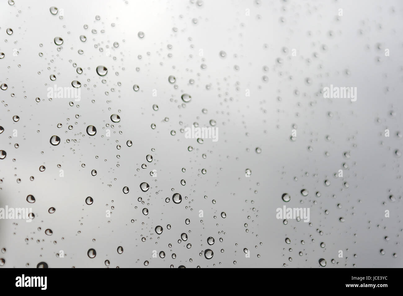 Drops of rain on the inclined window (glass). Shallow DOF Stock Photo ...