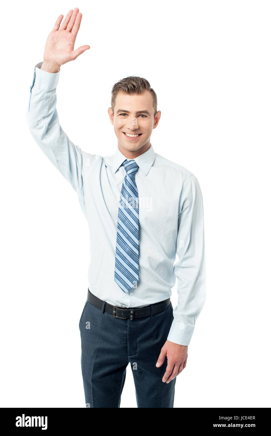Attractive businessman with his hand raised Stock Photo - Alamy