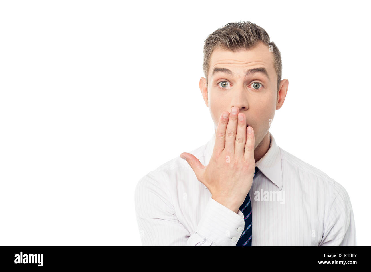 Young male executive with shocked facial expression Stock Photo - Alamy
