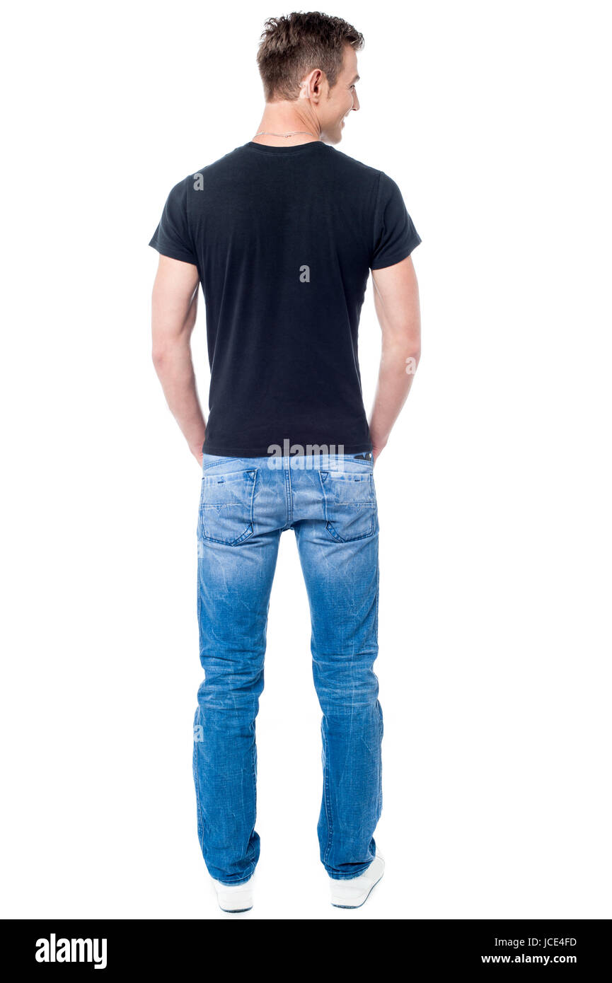 Back view of a young casual man with both hands in pockets Stock Photo ...