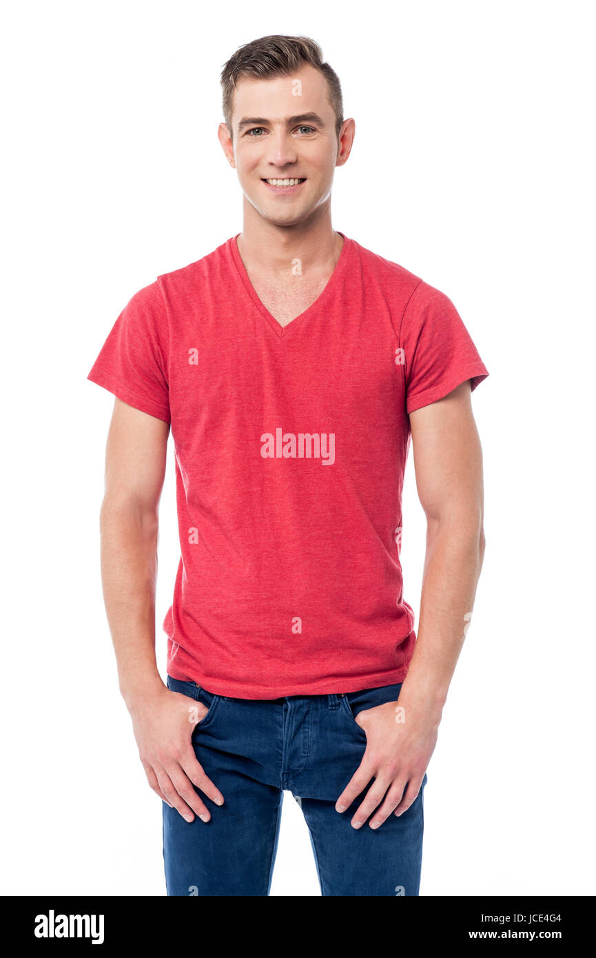 Handsome young man standing with hands in his pocket Stock Photo - Alamy