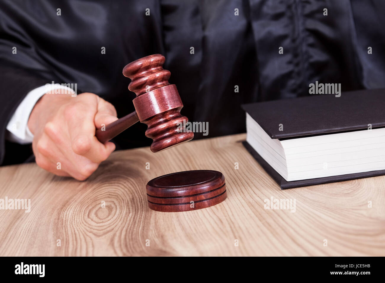 Male Judge In A Courtroom Striking The Gavel Stock Photo - Alamy
