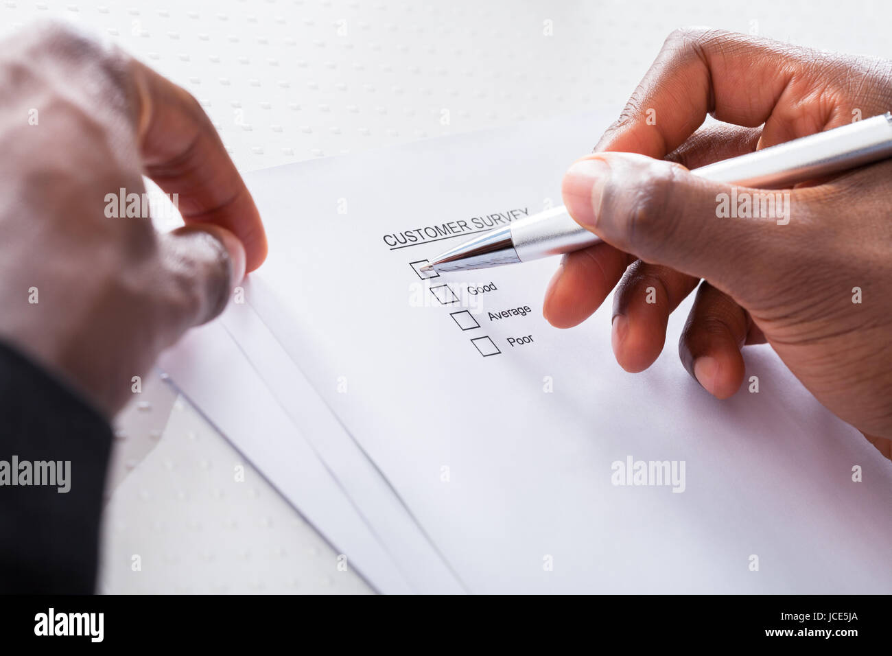 Close-up Of Human Hand Filling Customer Survey Form Stock Photo - Alamy