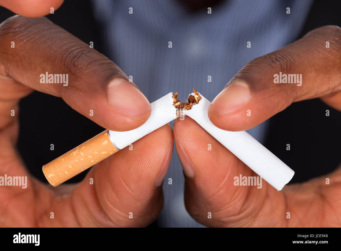 Close-up Of Human Hands Breaking The Cigarette Stock Photo - Alamy