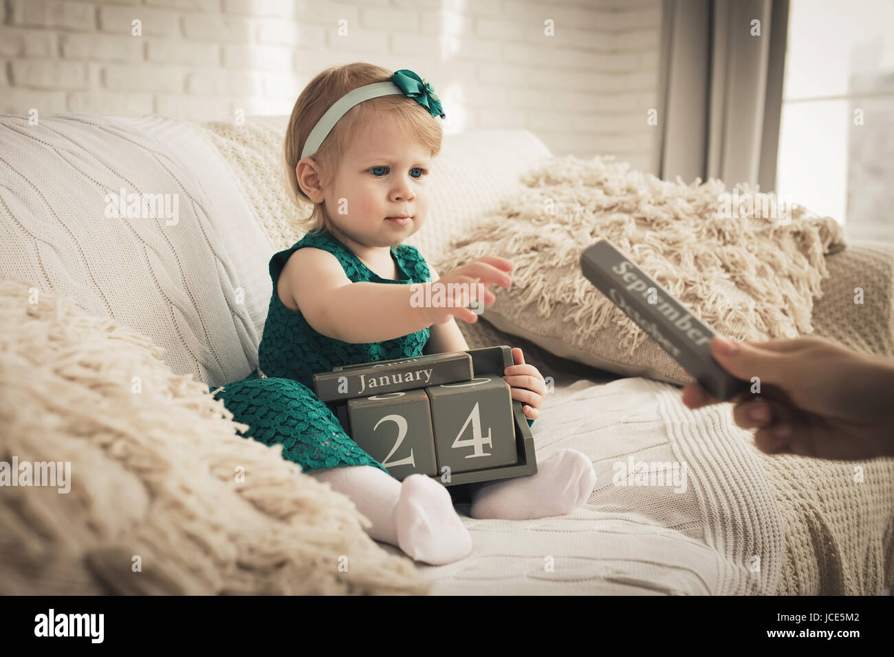 Kid studying month names close-up. Beautiful little girl playing with ...