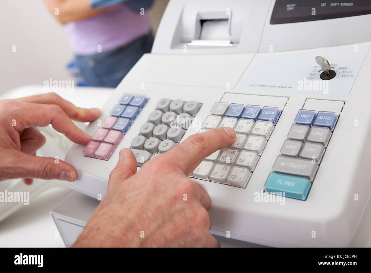 Sales person entering amount on cash register in retail store Stock ...