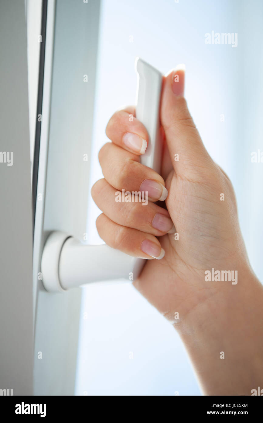 Close-up Of Female Hand Holding White Handle Stock Photo - Alamy