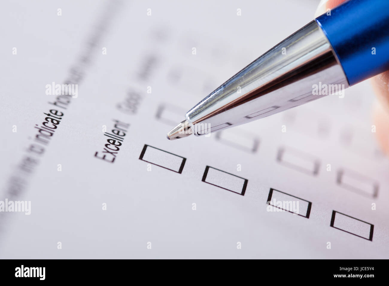 Close-up Of Hand Holding Pen Over Survey Form Stock Photo - Alamy