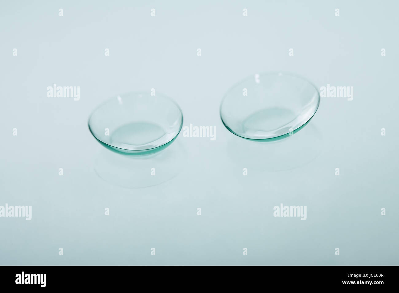 Pair of soft contact lenses lying in a concave position showing the ...