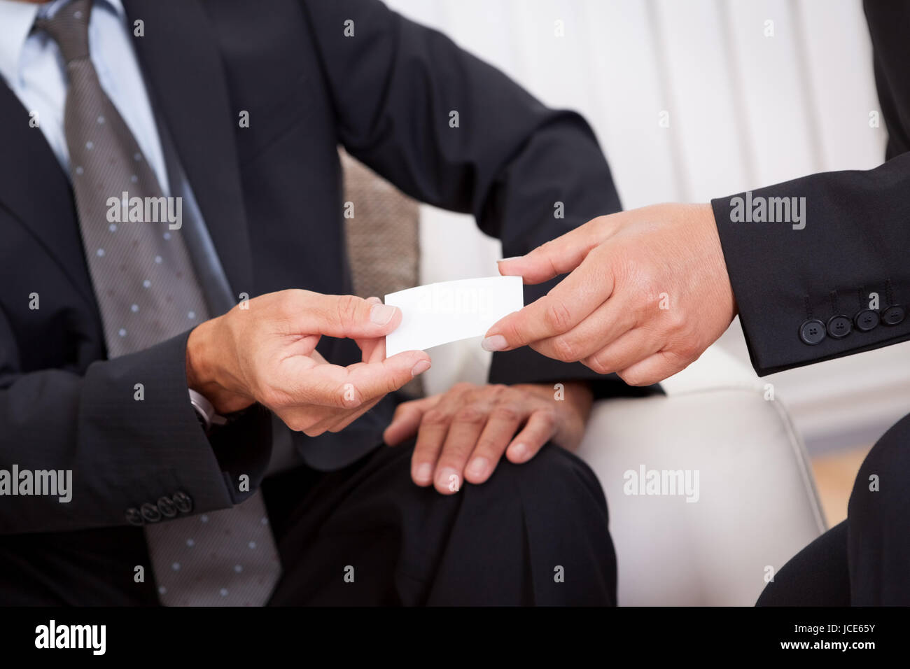 Business card being passed over between a male and female ...